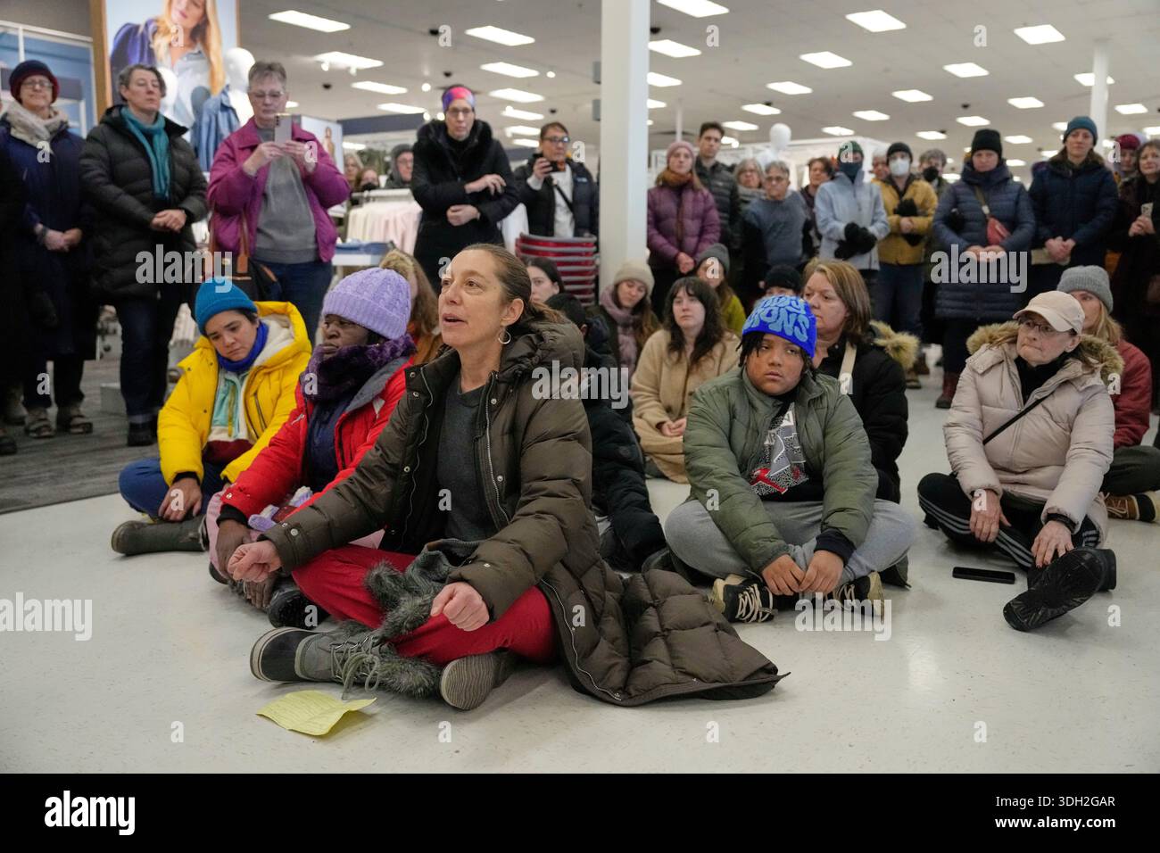 Community members and neighbors of people detained by ICE protest at a ...