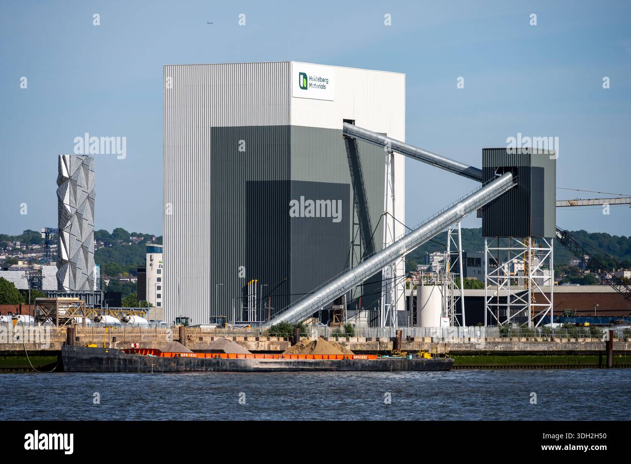 An aggregates barge is moored on the River Thames wharf of Victoria ...
