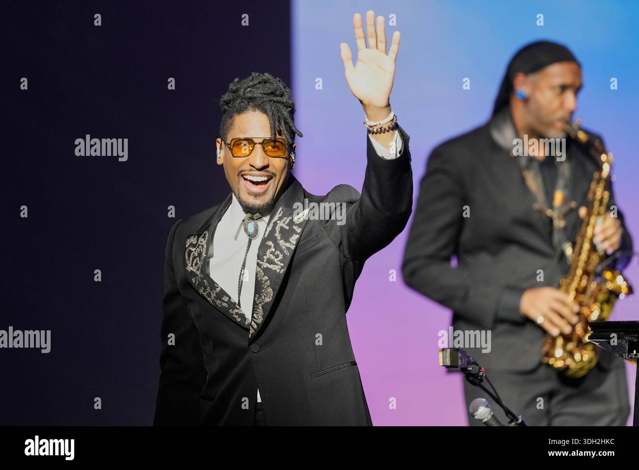 American singer Jon Batiste waves from the podium during the opening ...