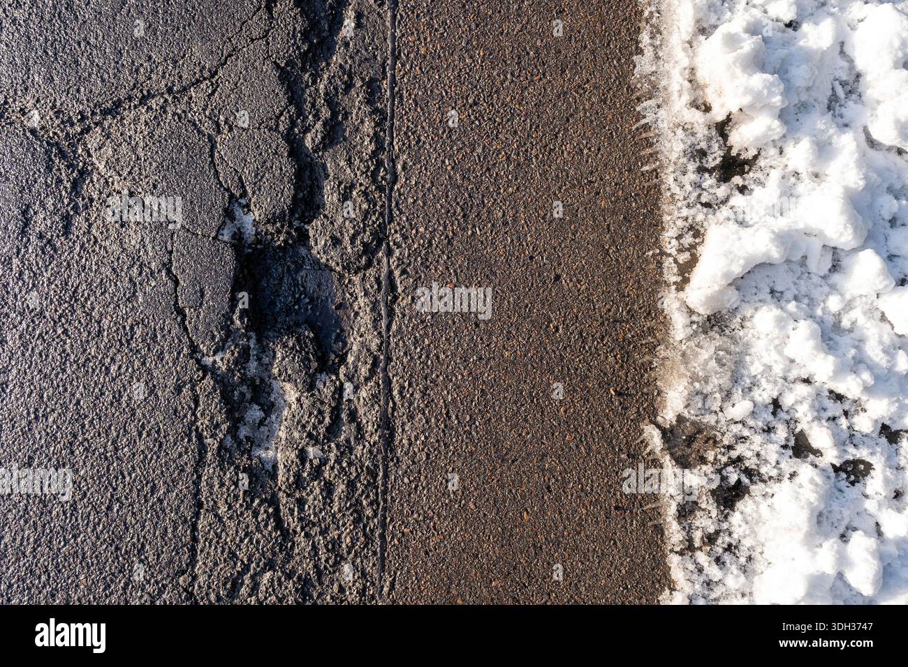 frost damage to the asphalt surface of a road Stock Photo - Alamy