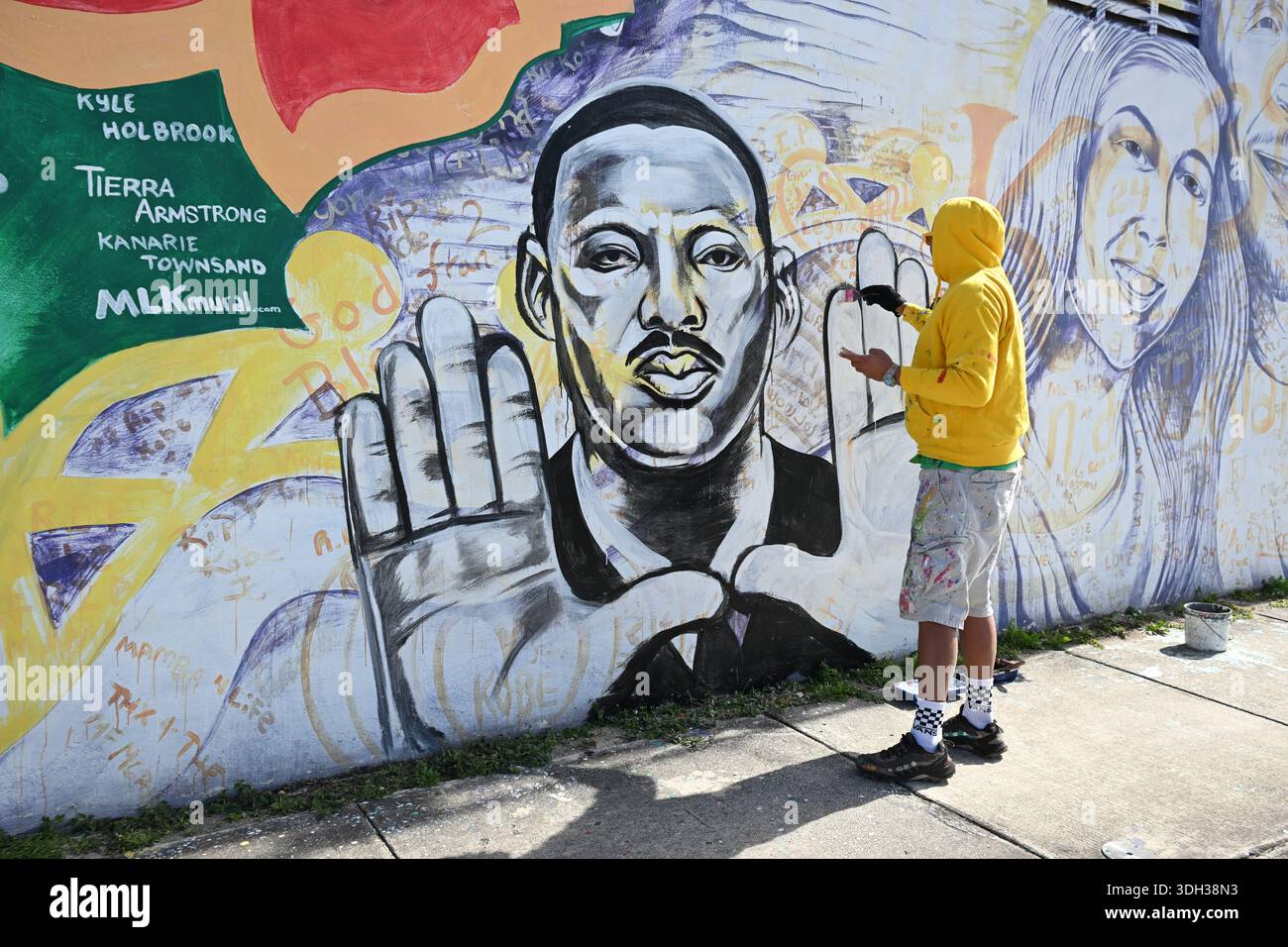 Miami, USA. 19th Jan, 2026. Artist Kyle Holbrook paints a mural of ...