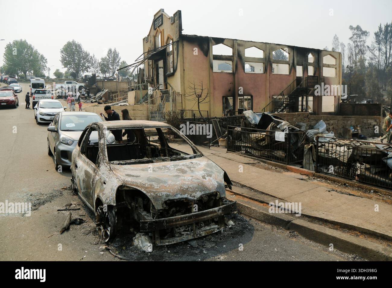 A car and a church in the background burned after the wildfires that ...