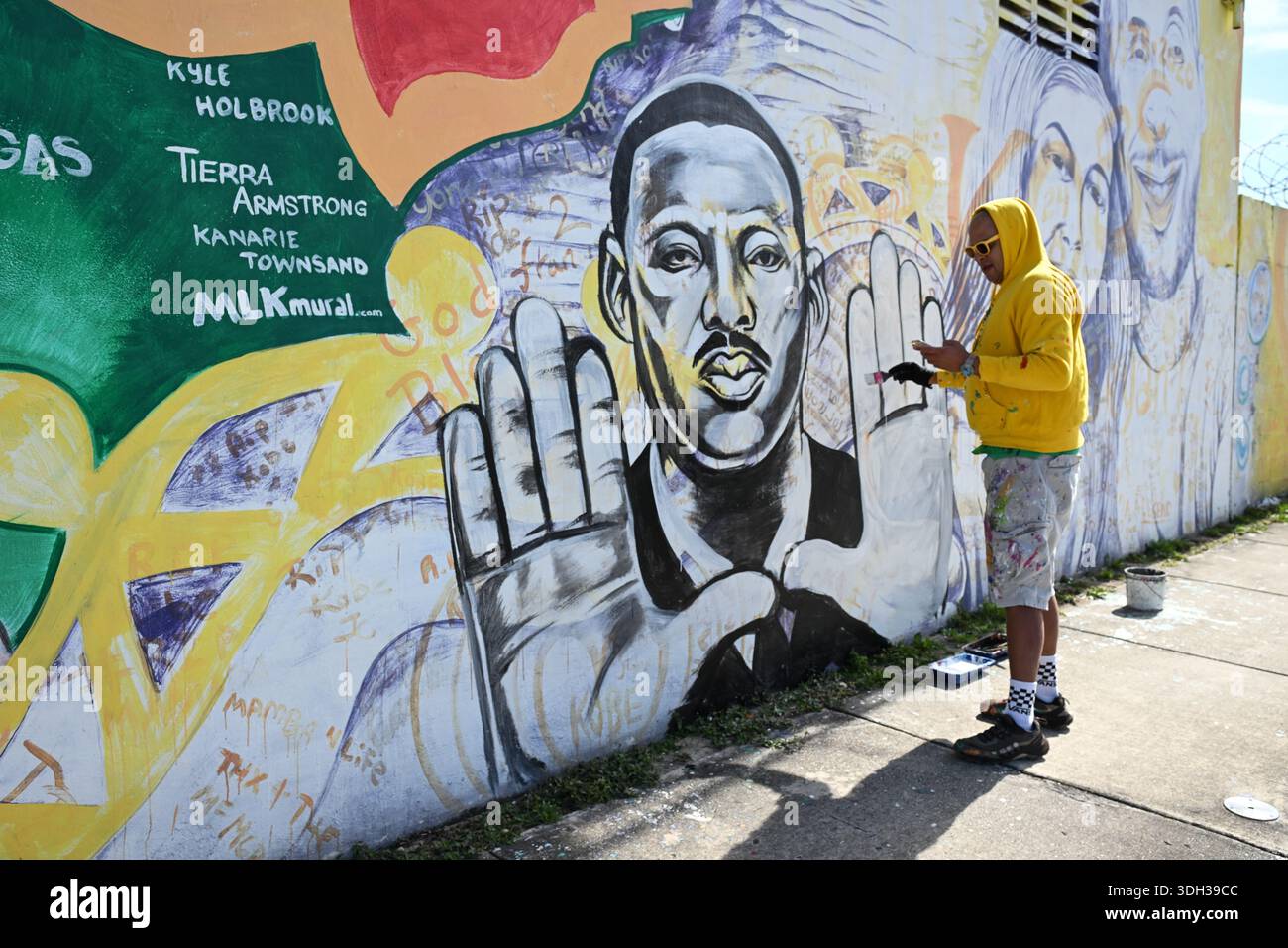 Miami, USA. 19th Jan, 2026. Artist Kyle Holbrook paints a mural of ...
