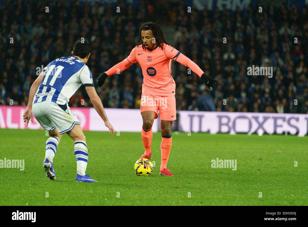 in action during the La Liga game between Real Sociedad and FC ...