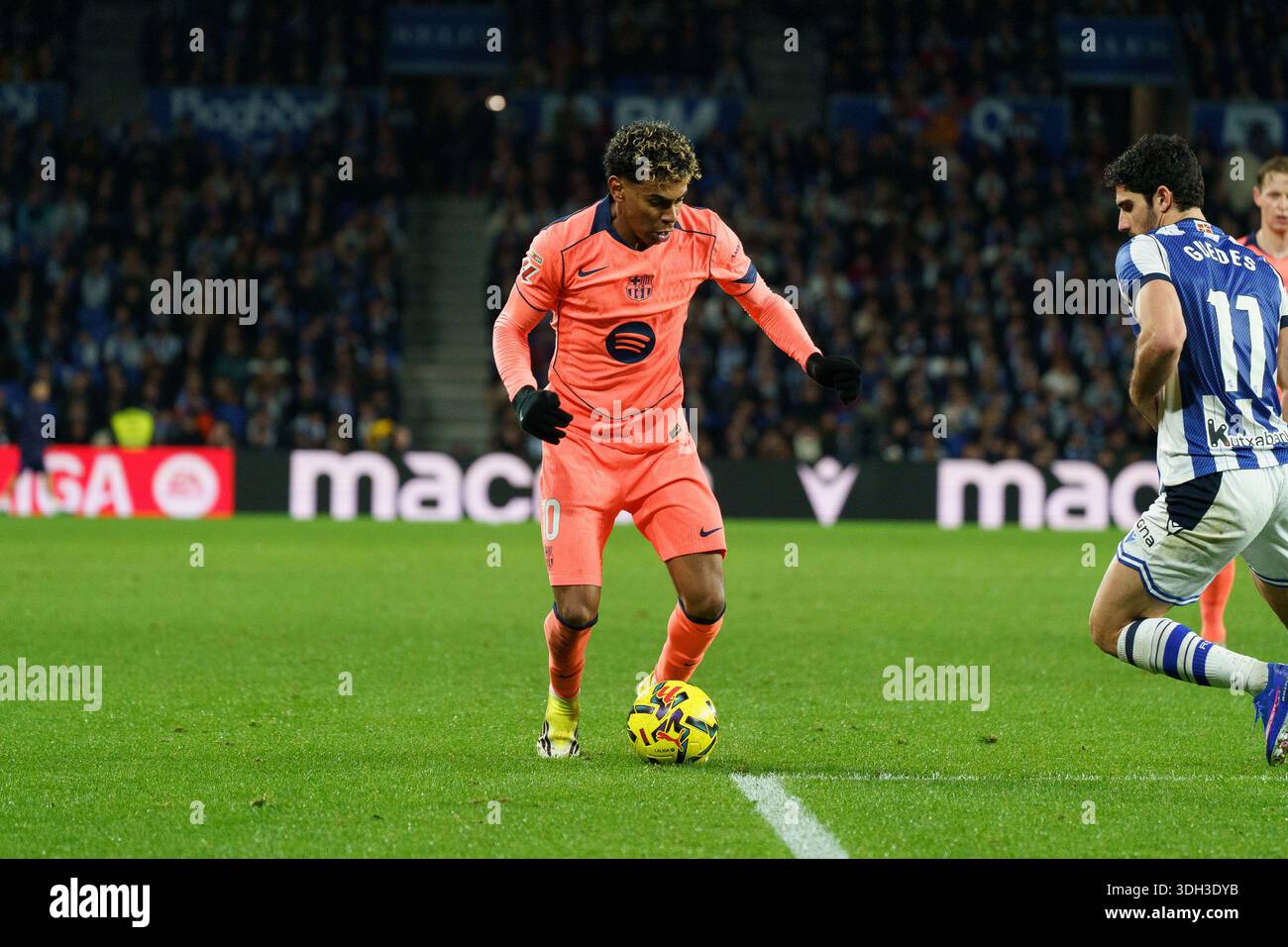 in action during the La Liga game between Real Sociedad and FC ...