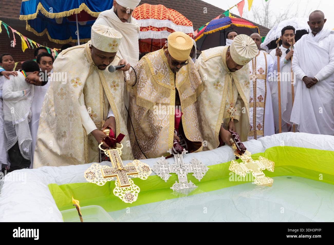 Seattle, Washington, USA. 19 January 2026. Religious officials dip gold ...
