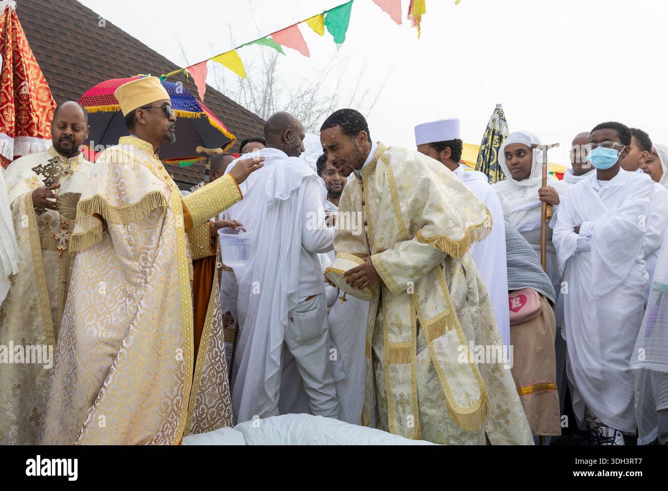 Seattle, Washington, USA. 19 January 2026. Priests splash congregants ...
