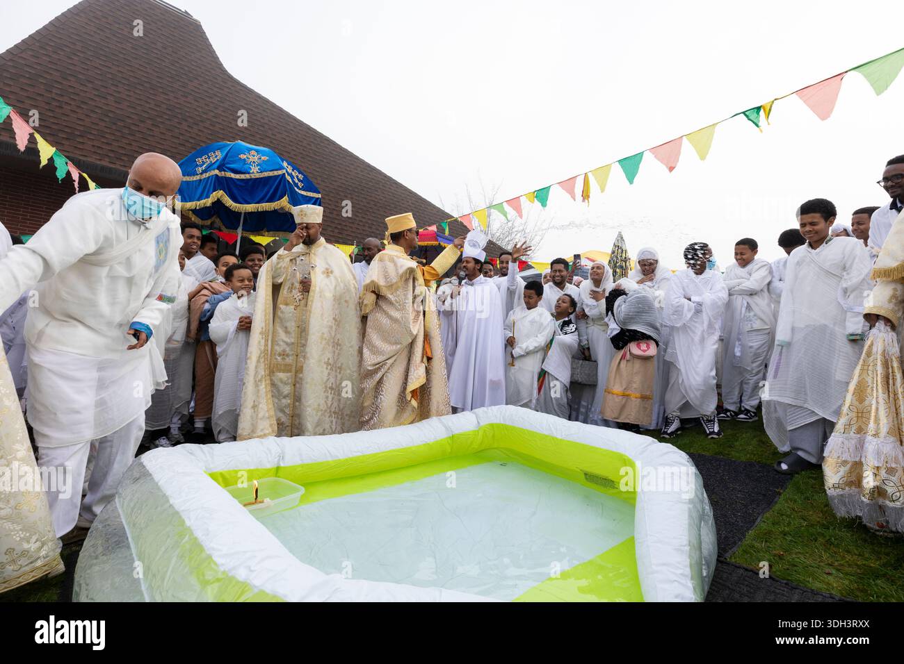 Seattle, Washington, USA. 19 January 2026. Priests splash congregants ...