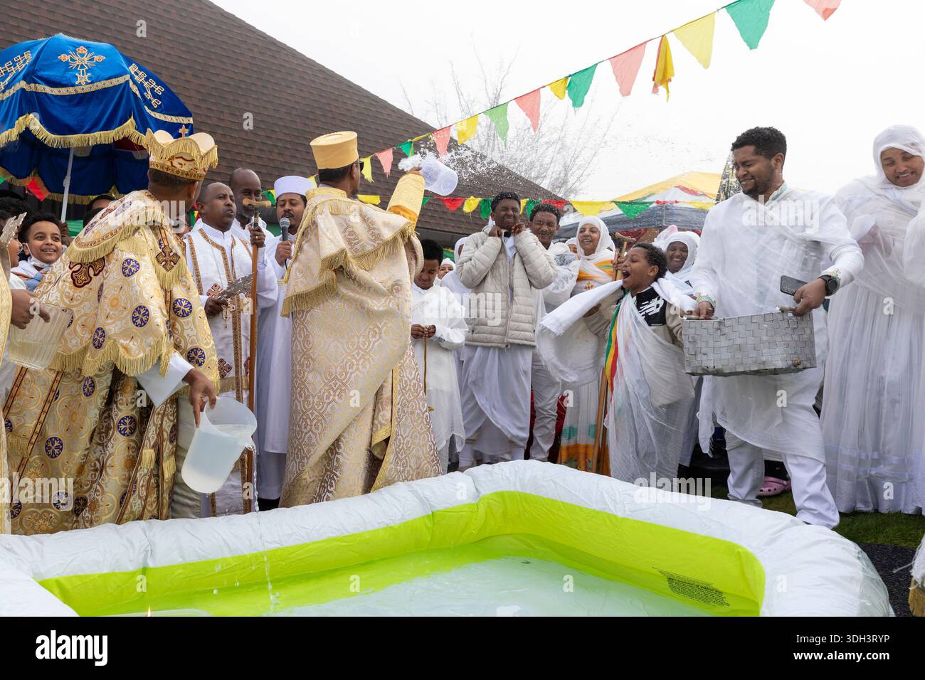 Seattle, Washington, USA. 19 January 2026. Priests splash congregants ...