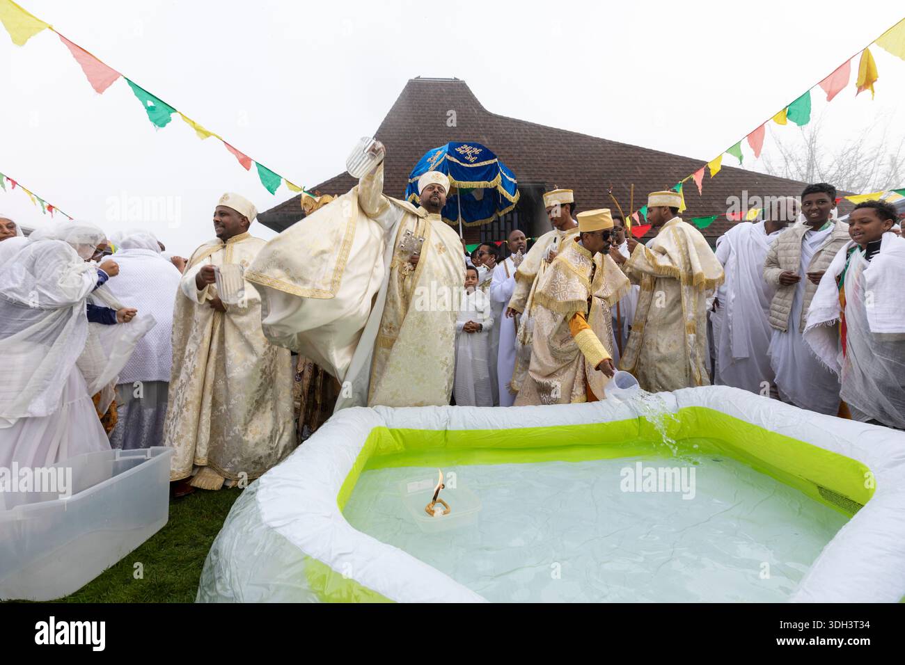 Seattle, Washington, USA. 19 January 2026. Priests splash congregants ...
