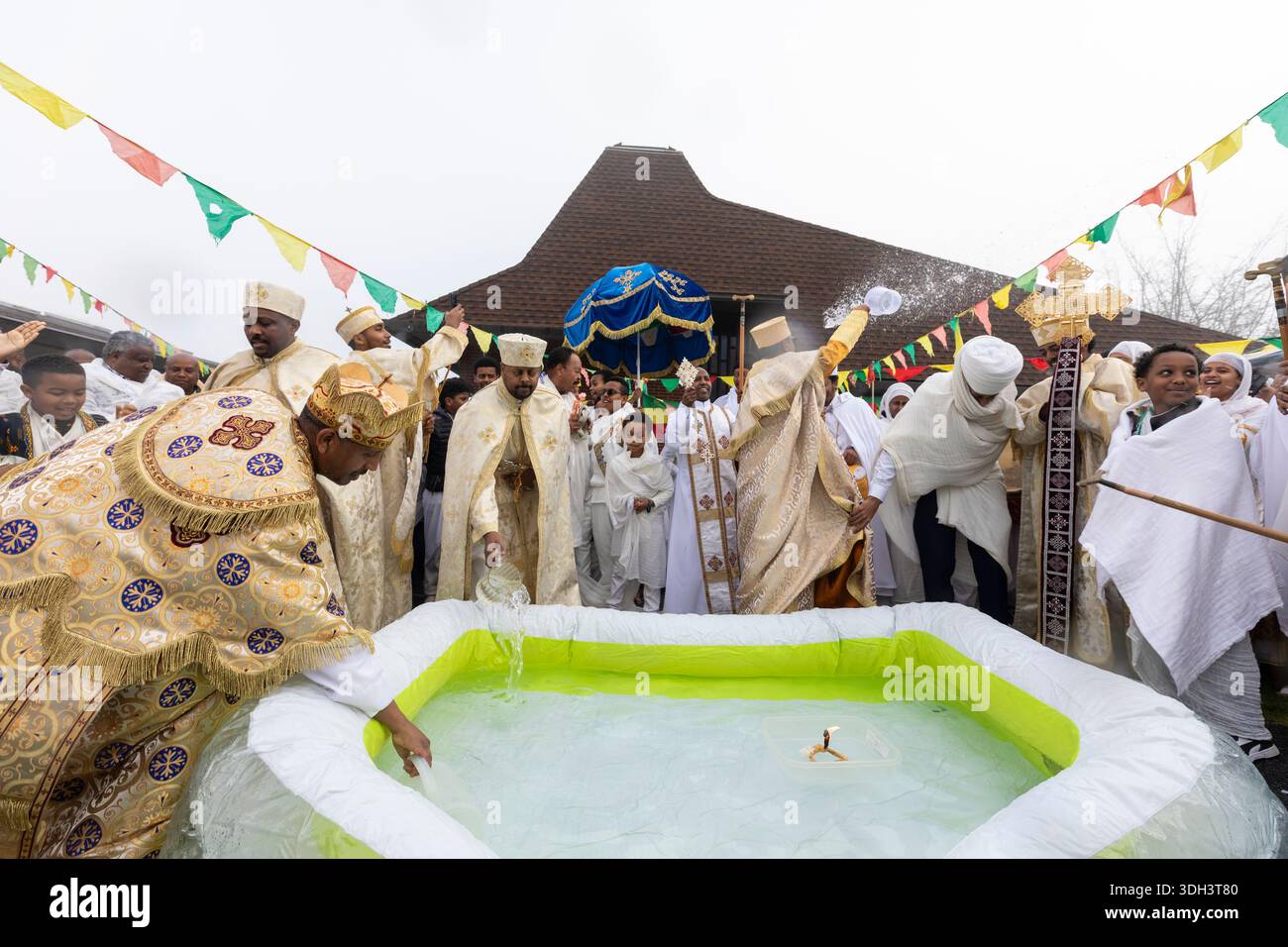 Seattle, Washington, USA. 19 January 2026. Priests splash congregants ...