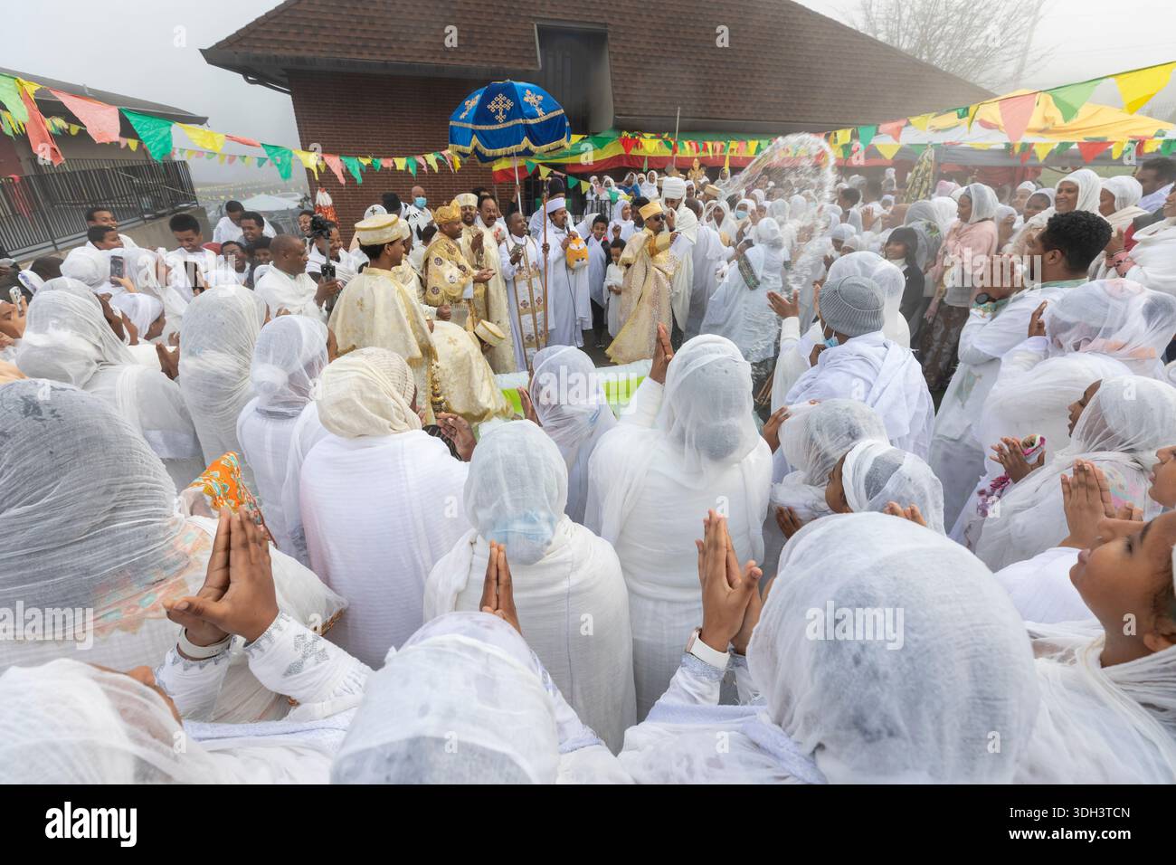 Seattle, Washington, USA. 19 January 2026. Priests splash congregants ...