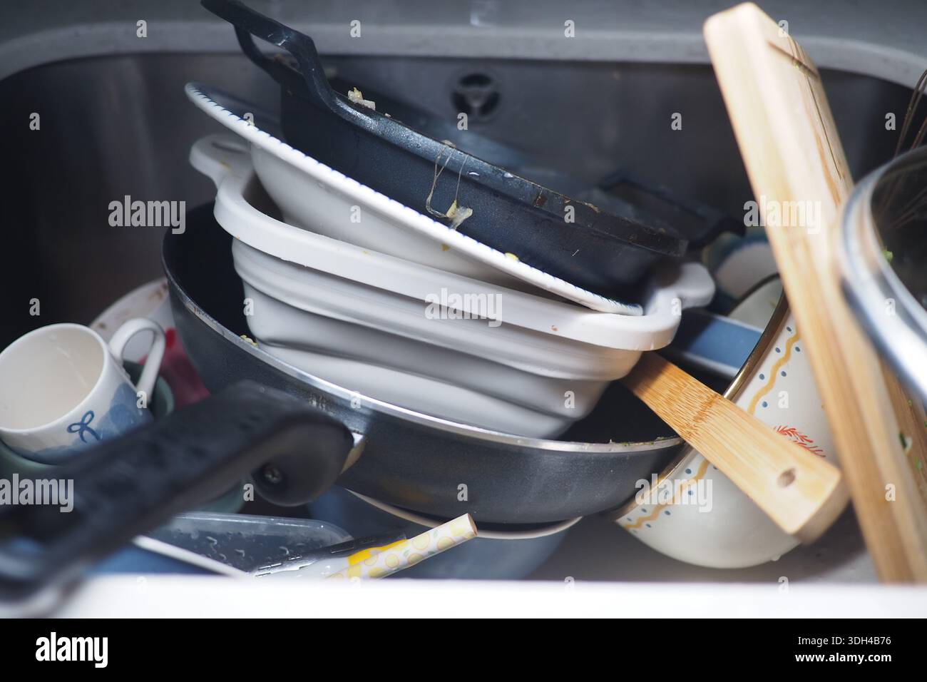 Dirty dishes fill sink hi-res stock photography and images - Alamy