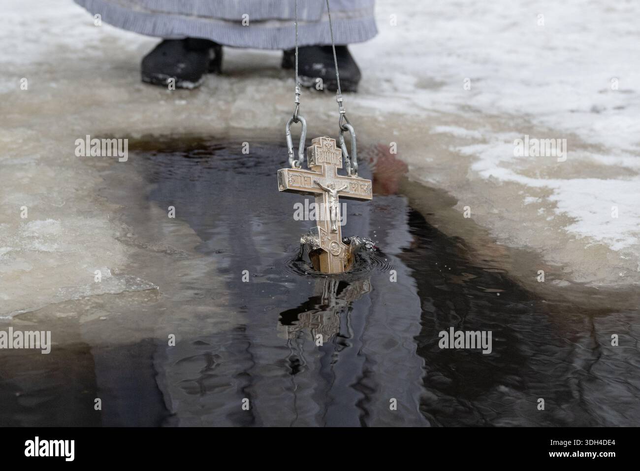 Saint Petersburg, Russia. 19th Jan, 2026. A priest performs the rite of ...