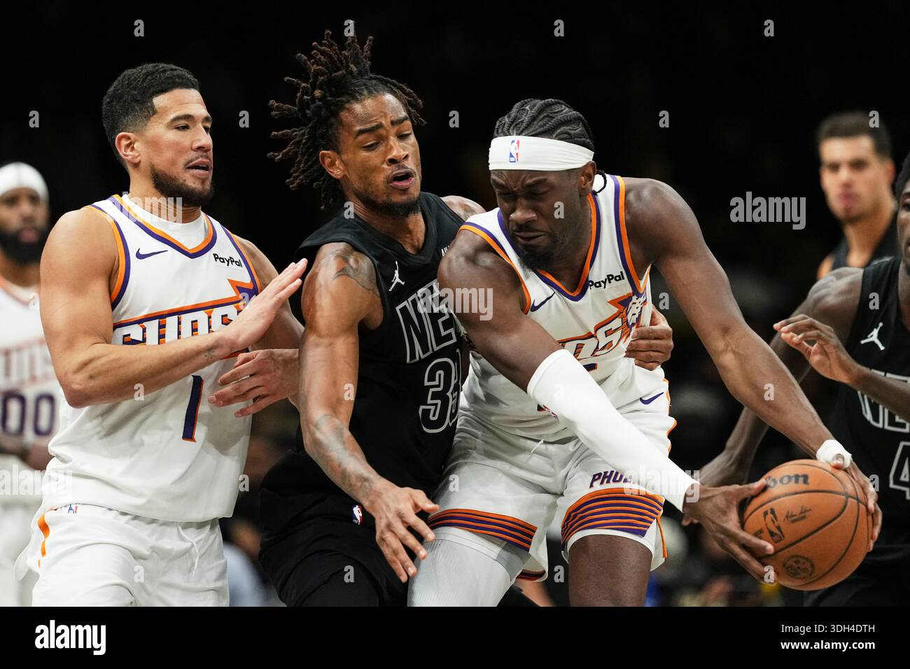 Phoenix Suns' Mark Williams, right, protects the ball from Brooklyn ...
