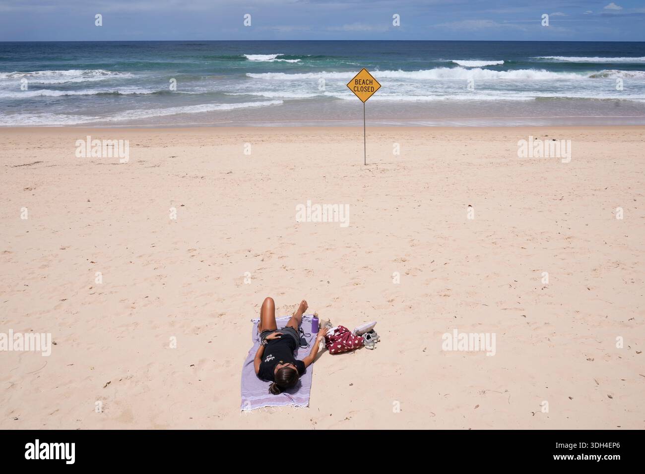 A lone sun bather relaxes at North Steyne Beach in Sydney, Tuesday, Jan ...