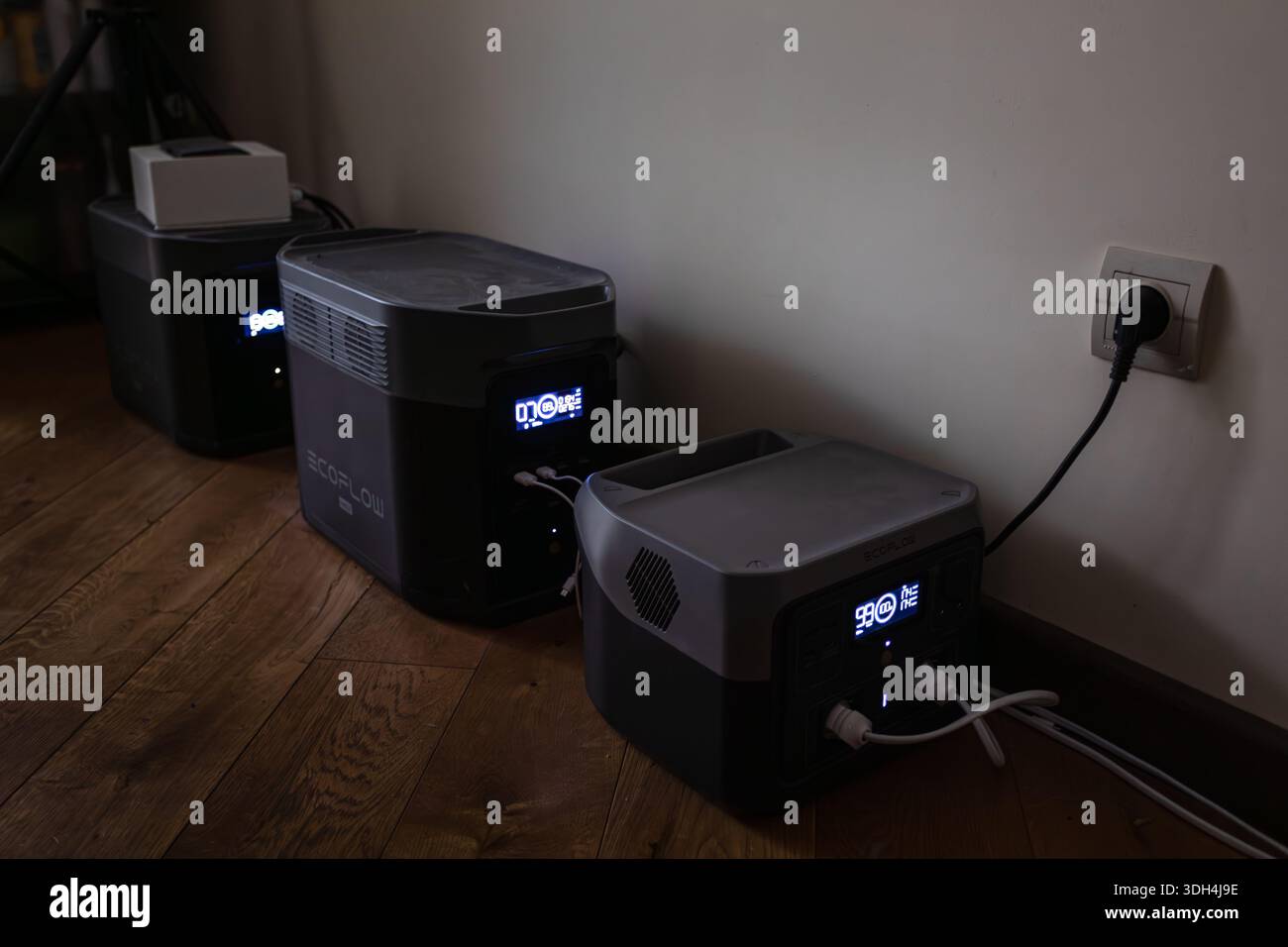 Three EcoFlow portable power stations are seen arranged on a floor in ...