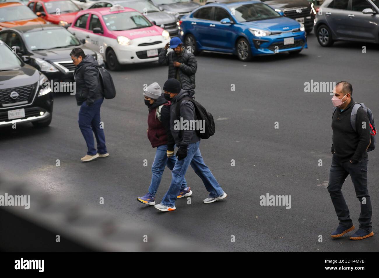 Non Exclusive: People wearing winter clothing bundle up after ...