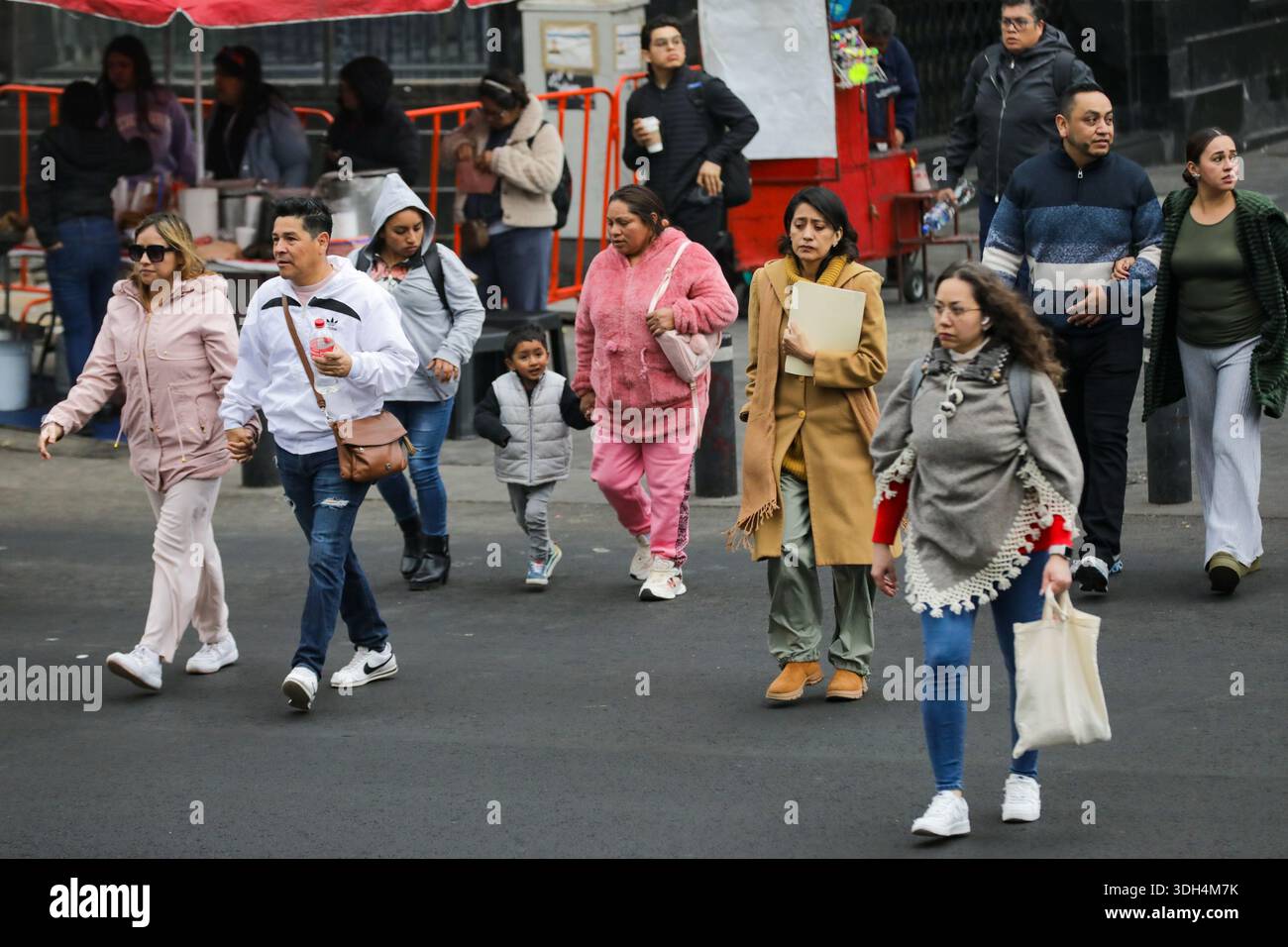 Non Exclusive: People wearing winter clothing bundle up after ...