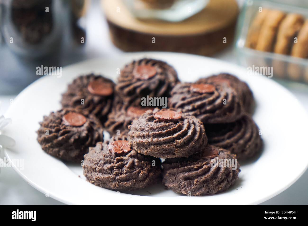 Homemade chocolate cookies with swirled ridges and a chocolate button ...