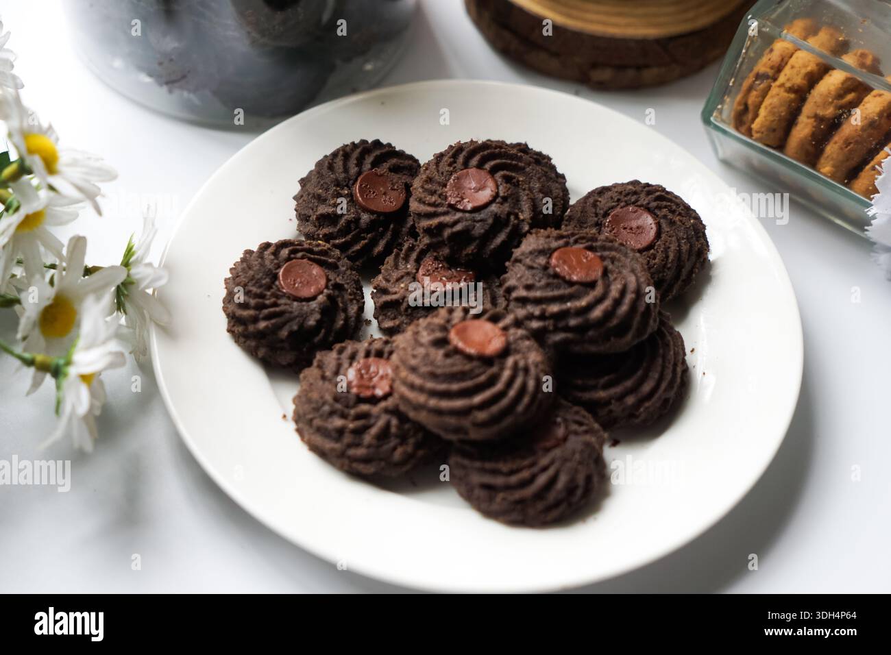 Homemade chocolate cookies with swirled ridges and a chocolate button ...