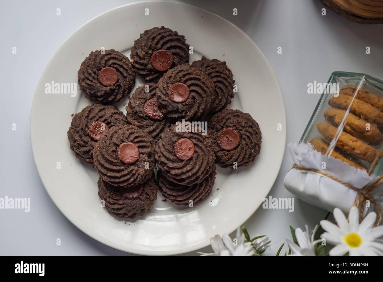 Homemade chocolate cookies with swirled ridges and a chocolate button ...