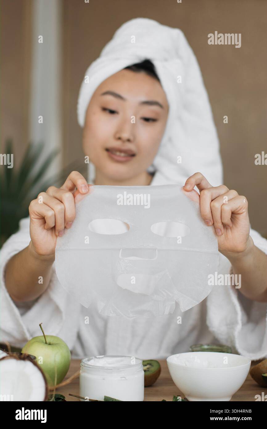 Woman Applying Face Mask Stock Photo - Alamy
