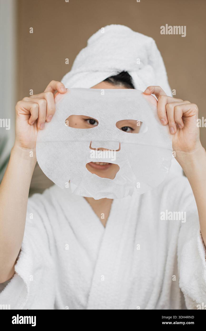 Woman Applying Face Mask Stock Photo - Alamy
