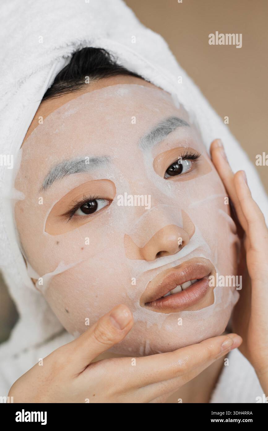 Woman Applying Sheet Mask Stock Photo - Alamy