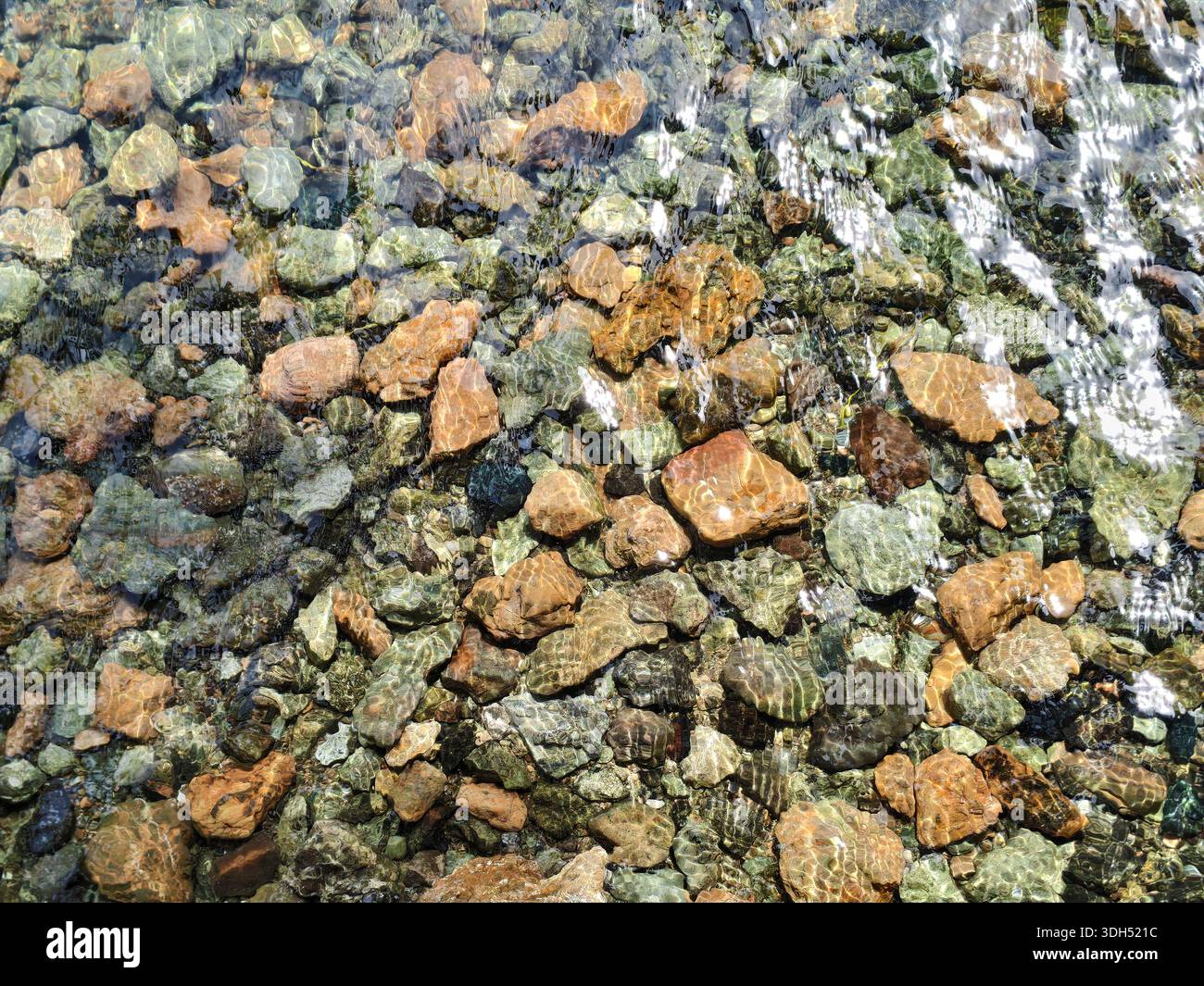 Colorful stones visible through transparent hi-res stock photography ...