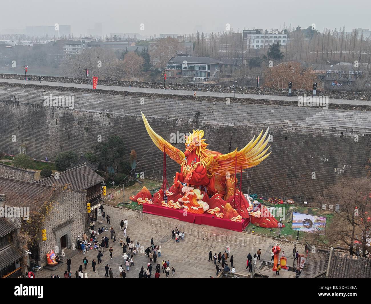 A giant flying horse lantern is completed under the Ming City Wall in ...