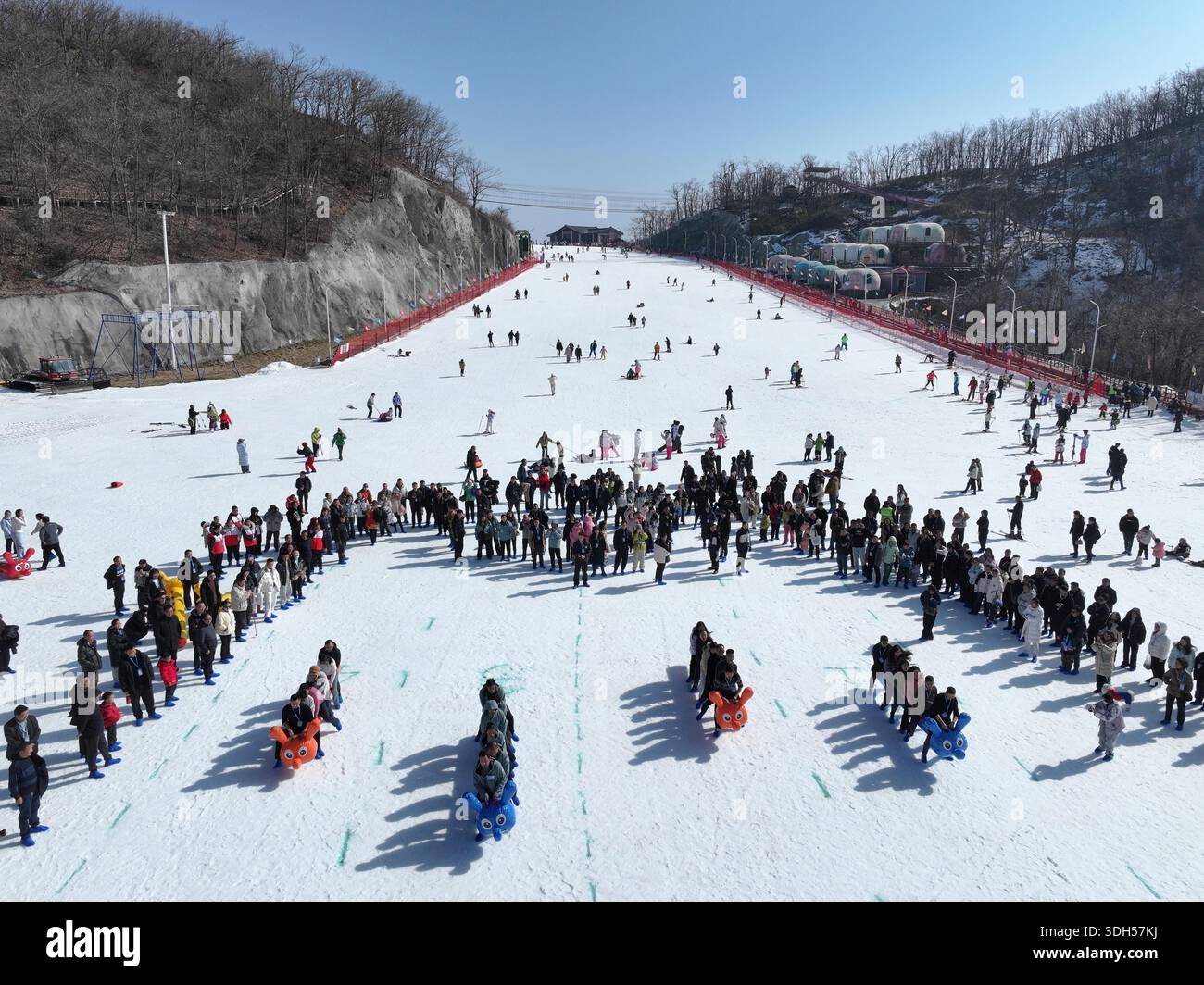 People take part in snow activities at Hengchong International Ski ...