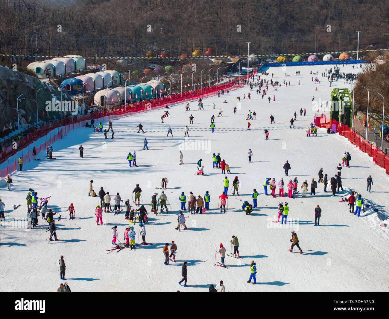 People take part in snow activities at Hengchong International Ski ...
