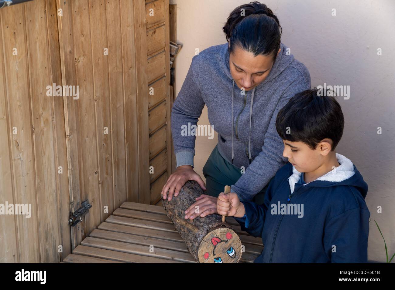 A family celebrates the Catalonian Tio de Nadal tradition. A child and ...