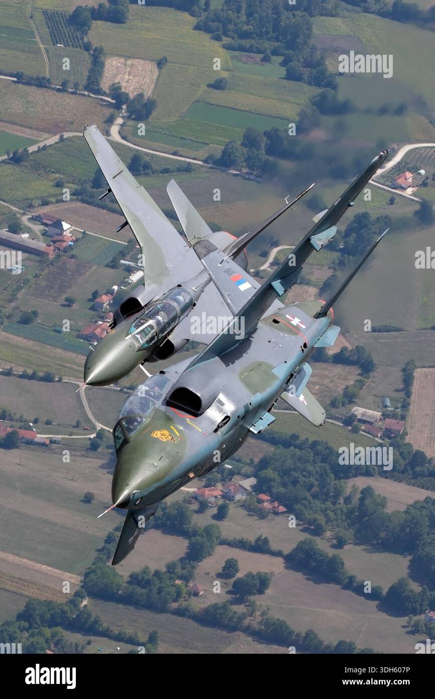 The photograph depicts two Serbian Air Force Soko NJ-22 Orao jets ...