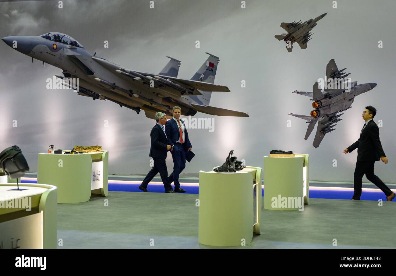 Doha, Qatar. 19th Jan, 2026. Attendees walk past a display featuring ...