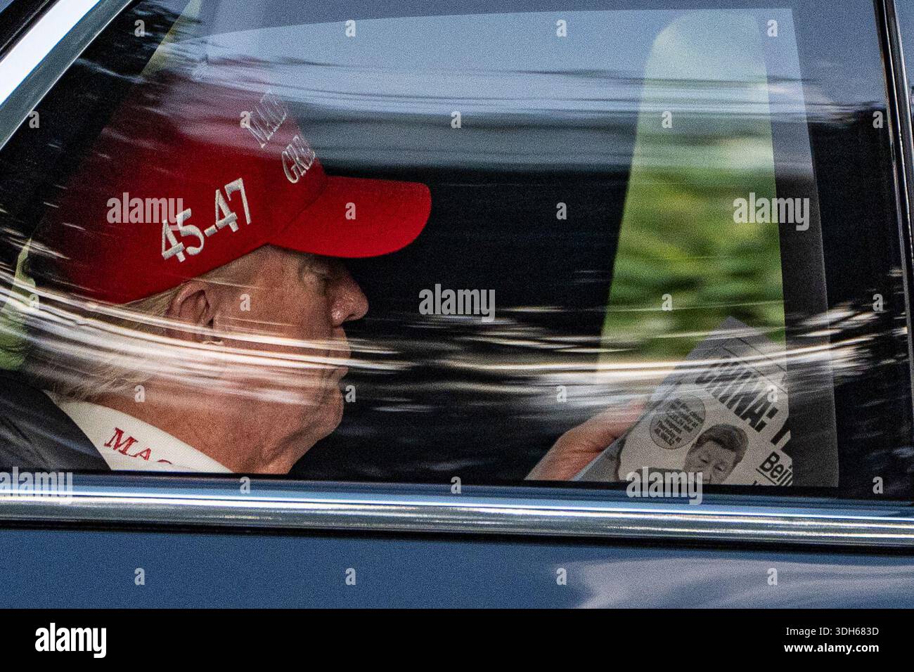FILE - President Donald Trump reads a copy of the New York Post as he ...