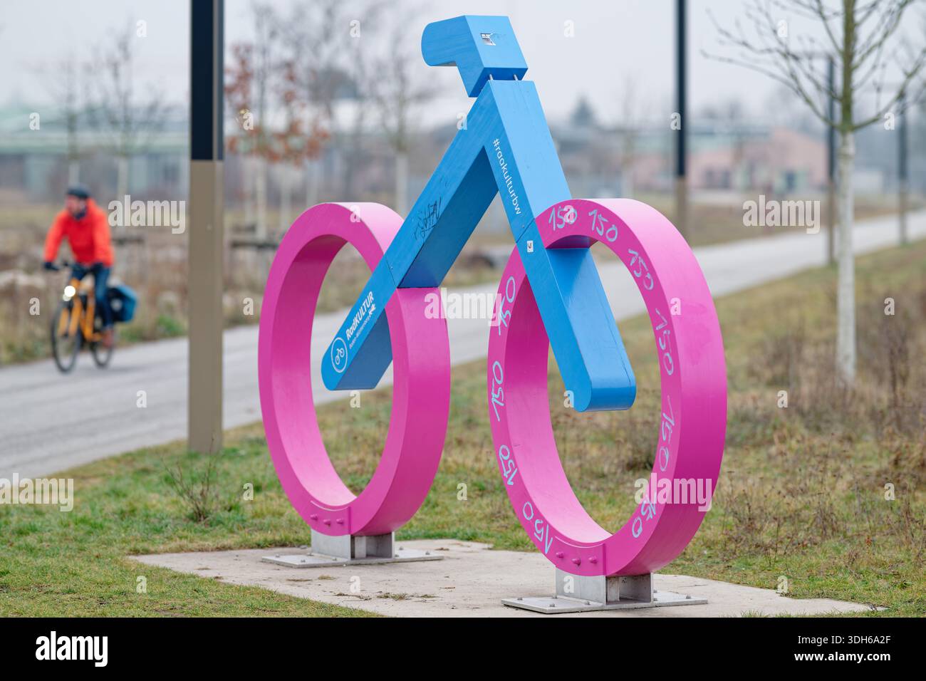Mannheim, Germany. 20th Jan, 2026. A cyclist rides past a colored ...