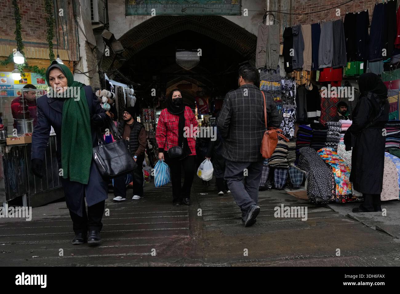 People walk at Tehran's historic Grand Bazaar, Tuesday, Jan. 20, 2026 ...