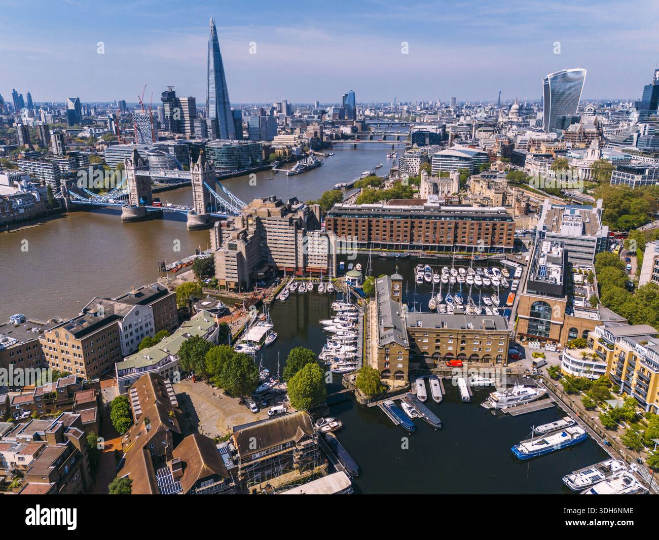 Aerial view of boats nestled in St Katharine Docks, contrasted against ...