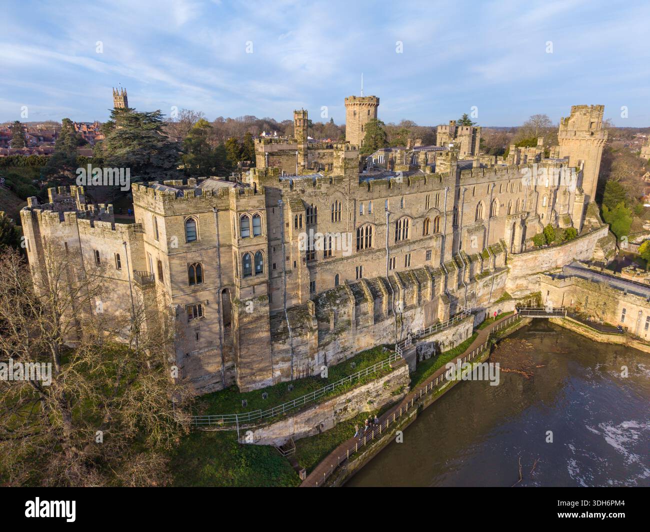 Aerial view of Warwick Castle's weathered stone walls rise majestically ...
