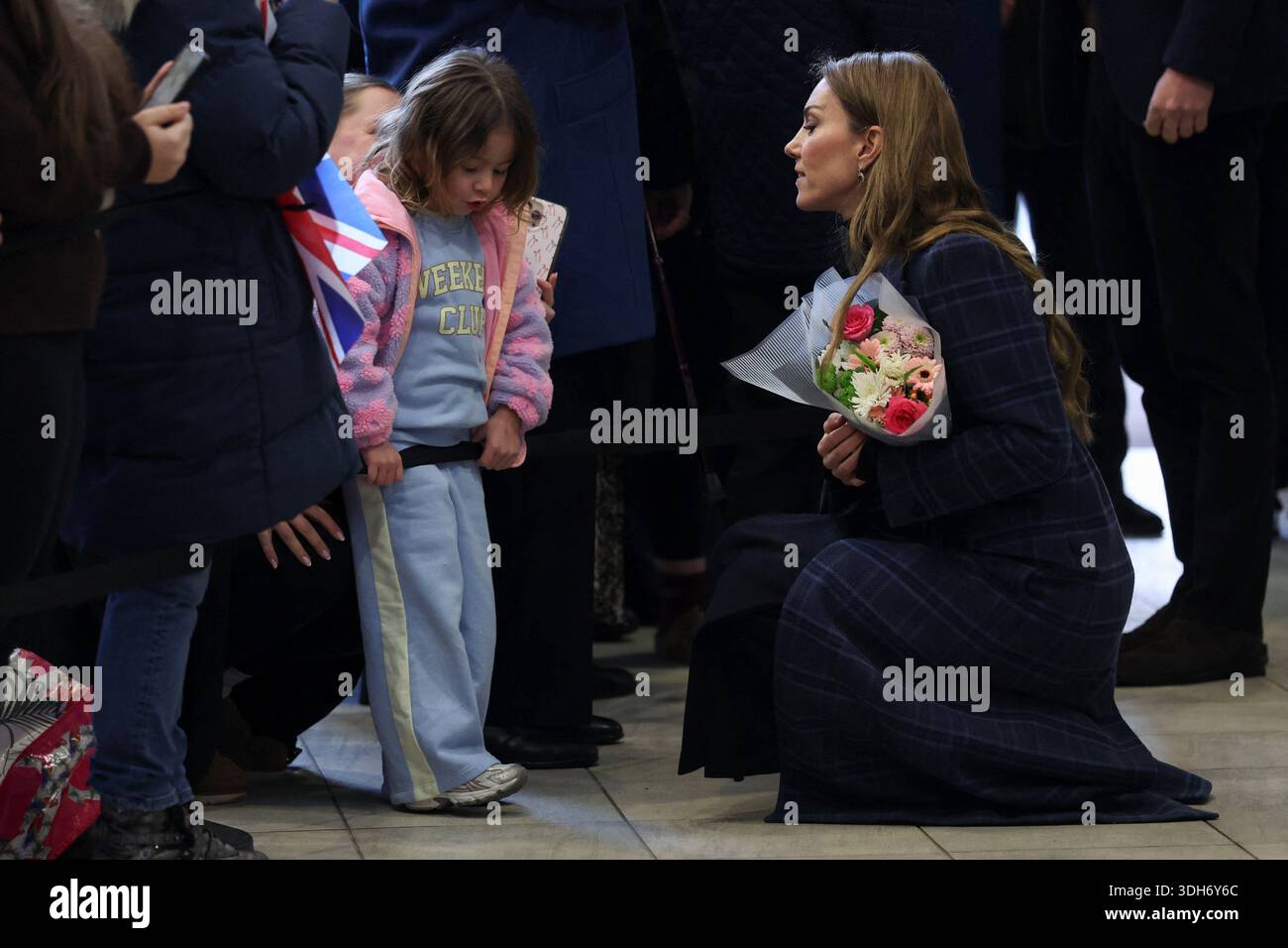 Britain's Kate, Princess of Wales speaks to a child while visiting the ...