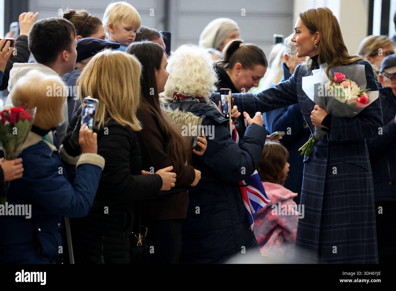 Britain's Kate, Princess of Wales greets people while visiting the ...