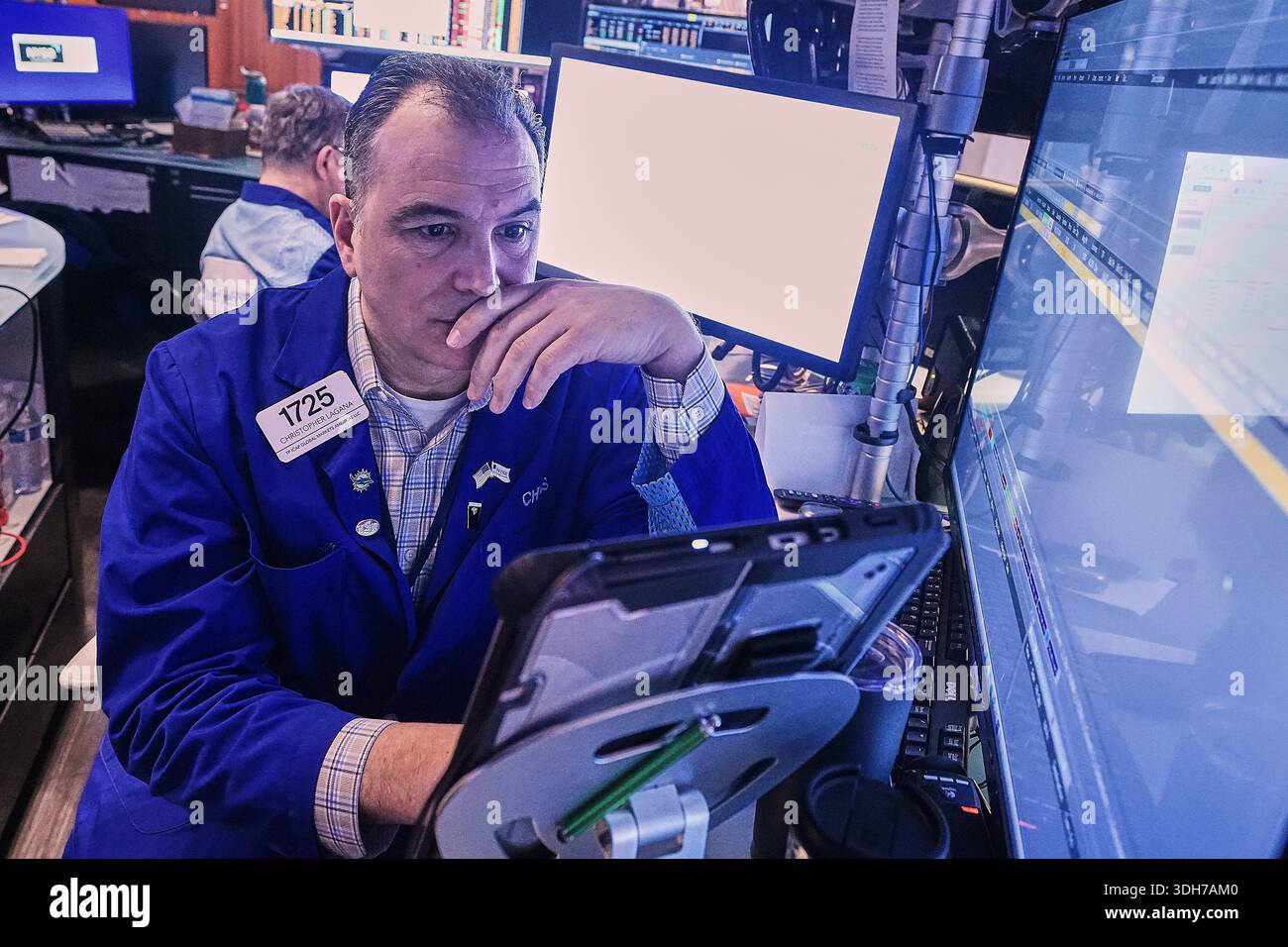 Trader Chris Lagana works on the floor of the New York Stock Exchange ...
