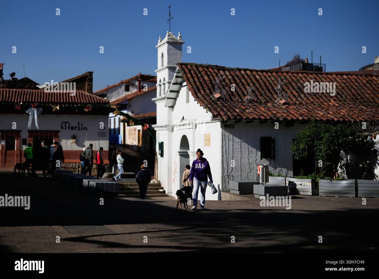People walk through Chorro de Quevedo square in Bogota, Colombia ...