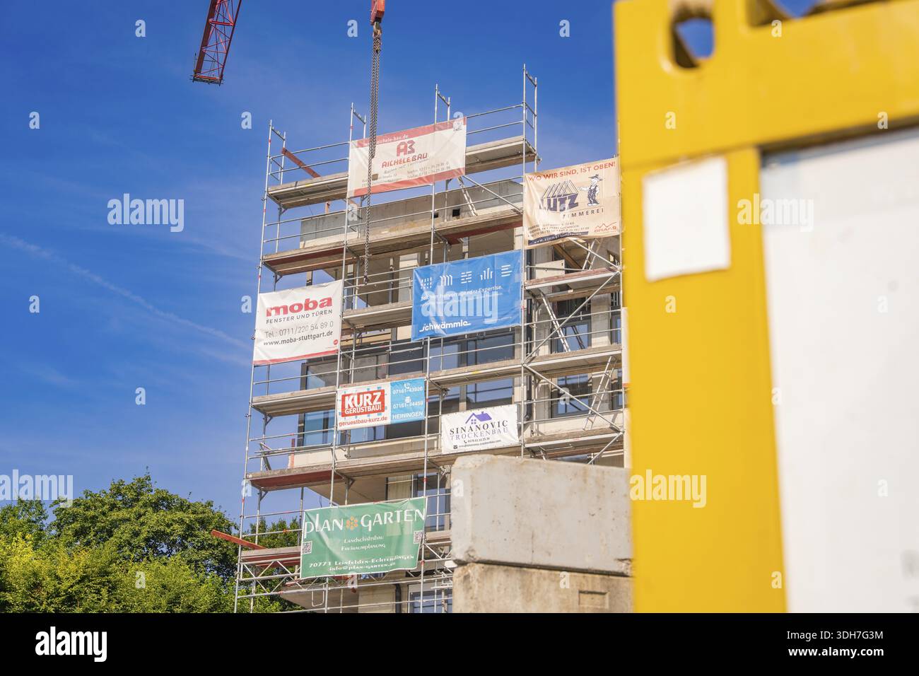 Multi-storey scaffolding structure with company logos on a sunny ...