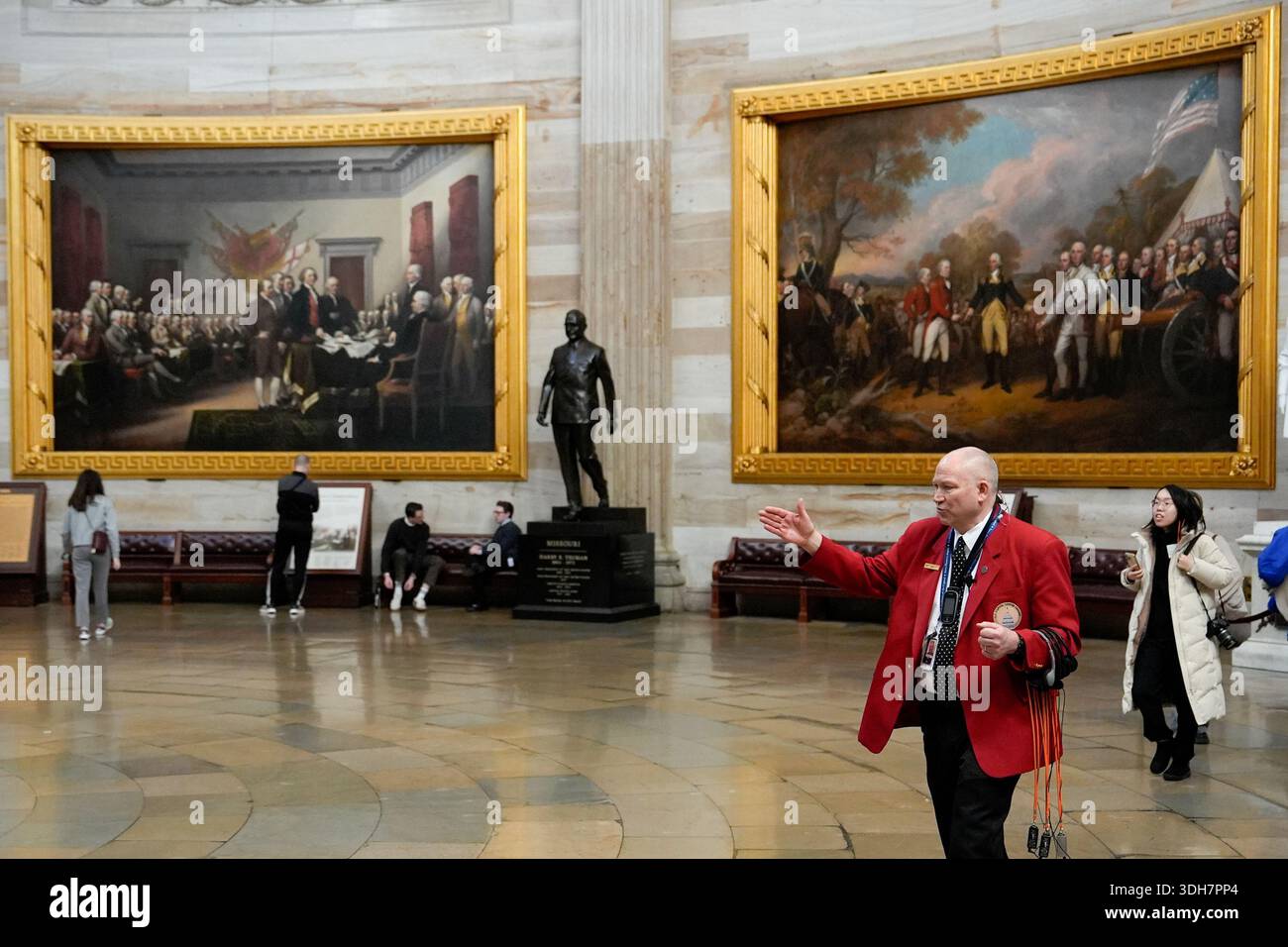 A tour guide walks through the U.S. Capitol Rotunda, where President ...