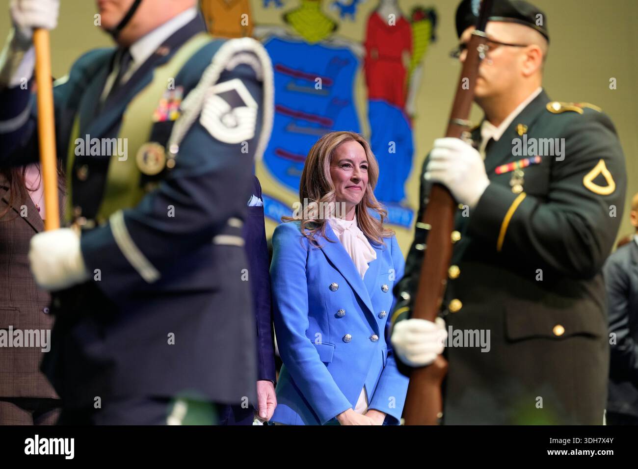 New Jersey Gov. Mikie Sherrill stands as an honor guard passes by ...