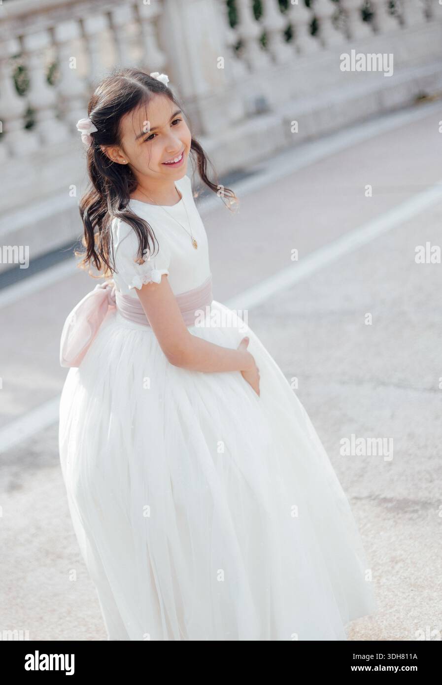 Smiling girl in white dress celebrating her first holy communion Stock ...
