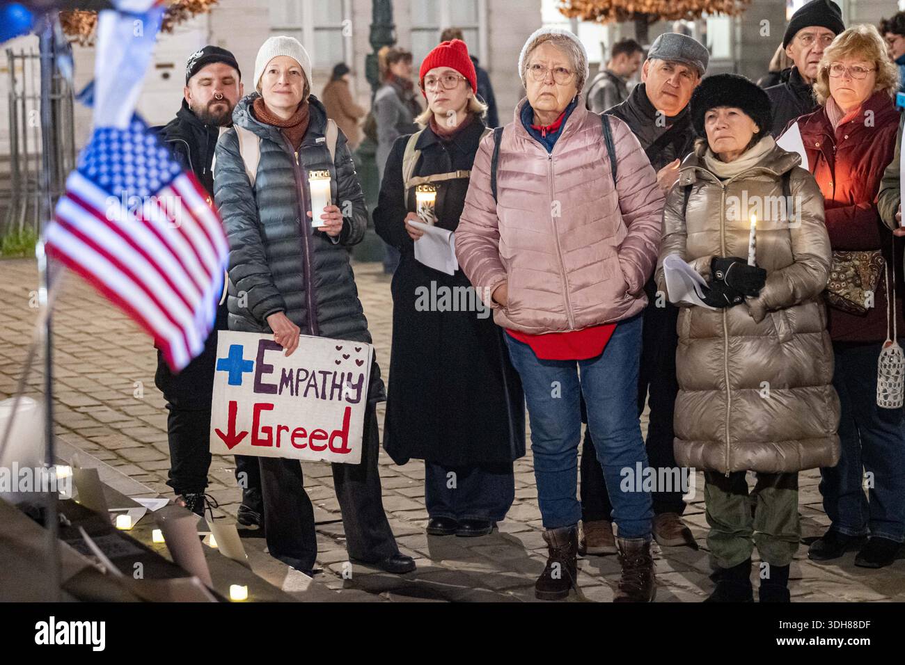 A woman holds a pamflet during a wake organized by Democrats Abroad ...